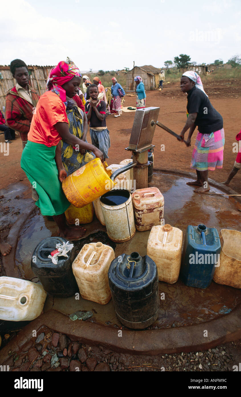 Somali refugee women pumping clean water from a pump in a Somali ...