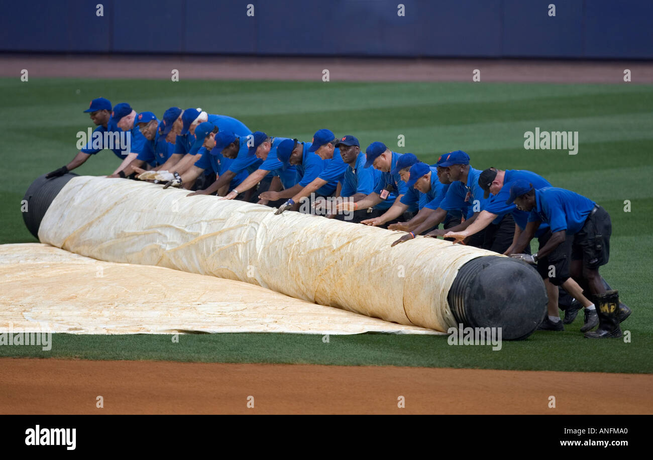 Workers covering the field at a baseball game Stock Photo - Alamy