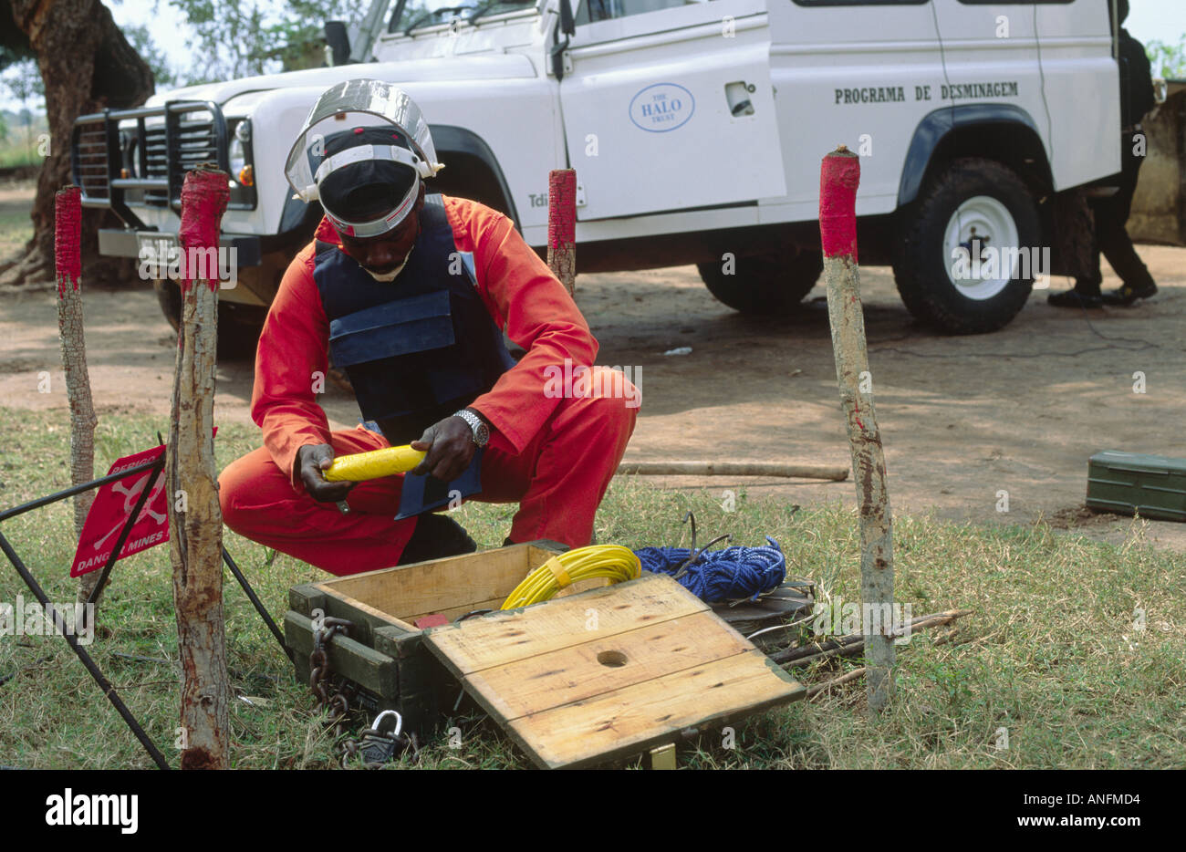 Mozambican landmine disposal expert preparing a charge for a controlled ...