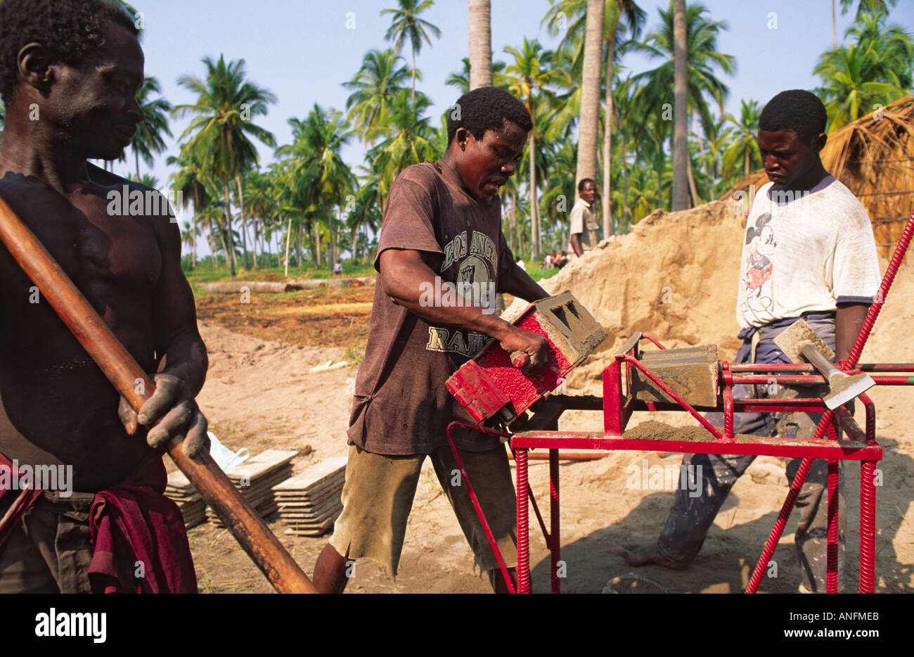 Labourers making building blocks for the construction of new homes for ...