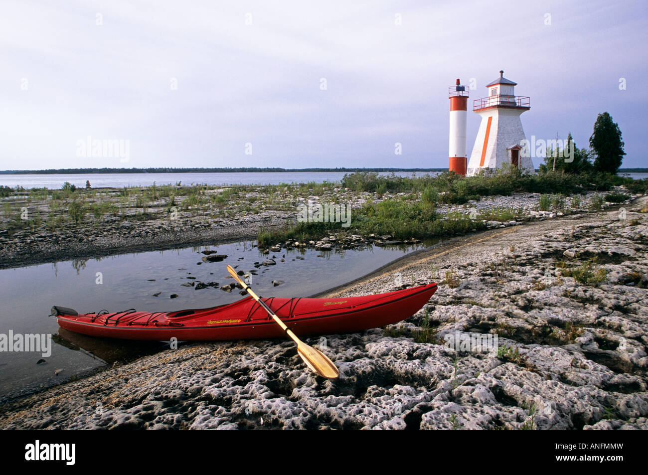 A kayak sits next to the Knife Island Lighthouse, located in Lake Huron ...