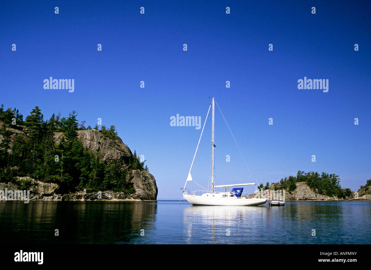 A sailboat moored in Sinclair Cove, Lake Superior Provincial Park ...