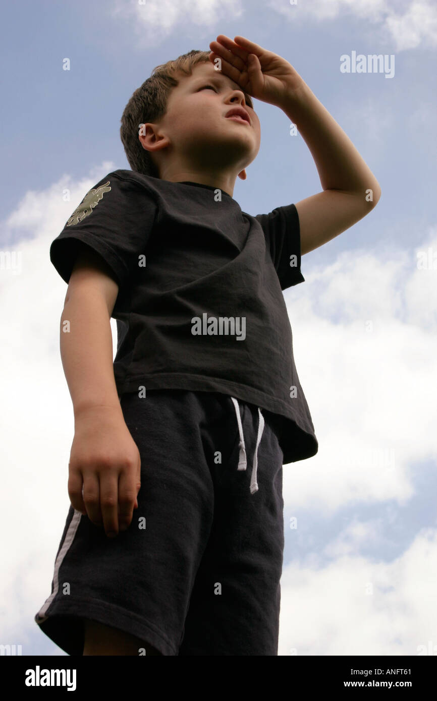 Young Boy looking upwards to the sky Stock Photo - Alamy