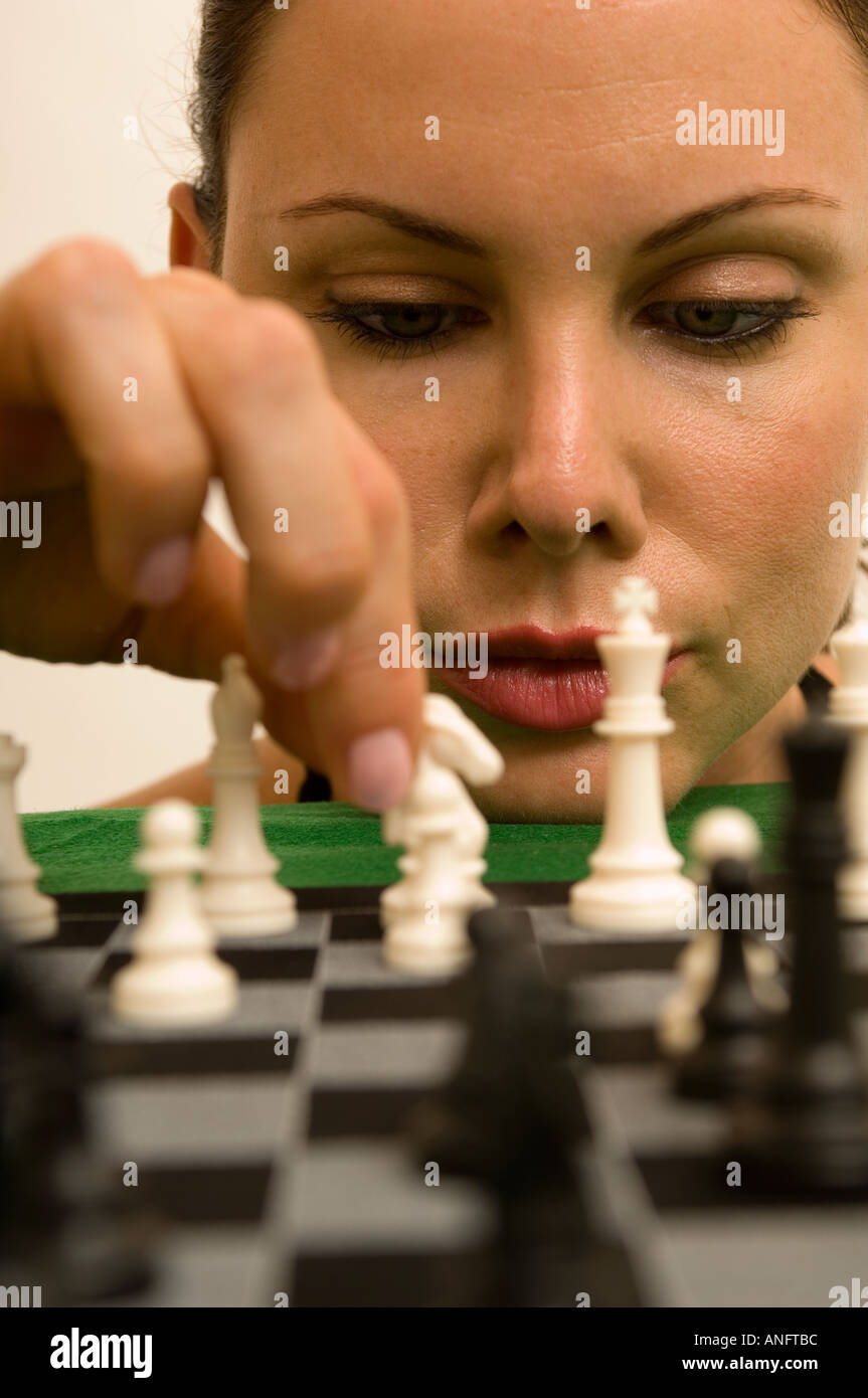 Portrait of a woman playing chess Stock Photo - Alamy