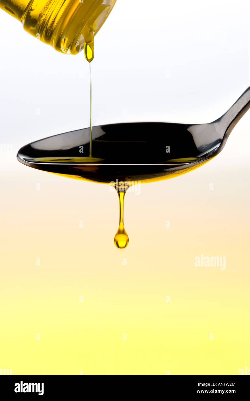 Oil pouring on spoon Stock Photo - Alamy