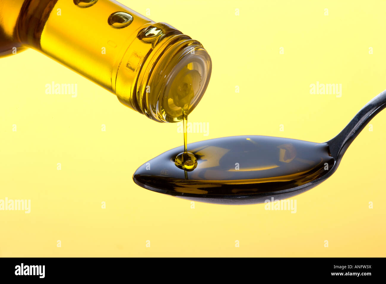 Oil pouring on spoon Stock Photo - Alamy