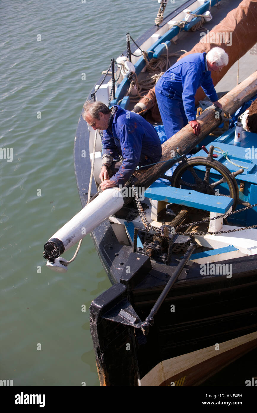 Boat workers repairing mast Stock Photo - Alamy