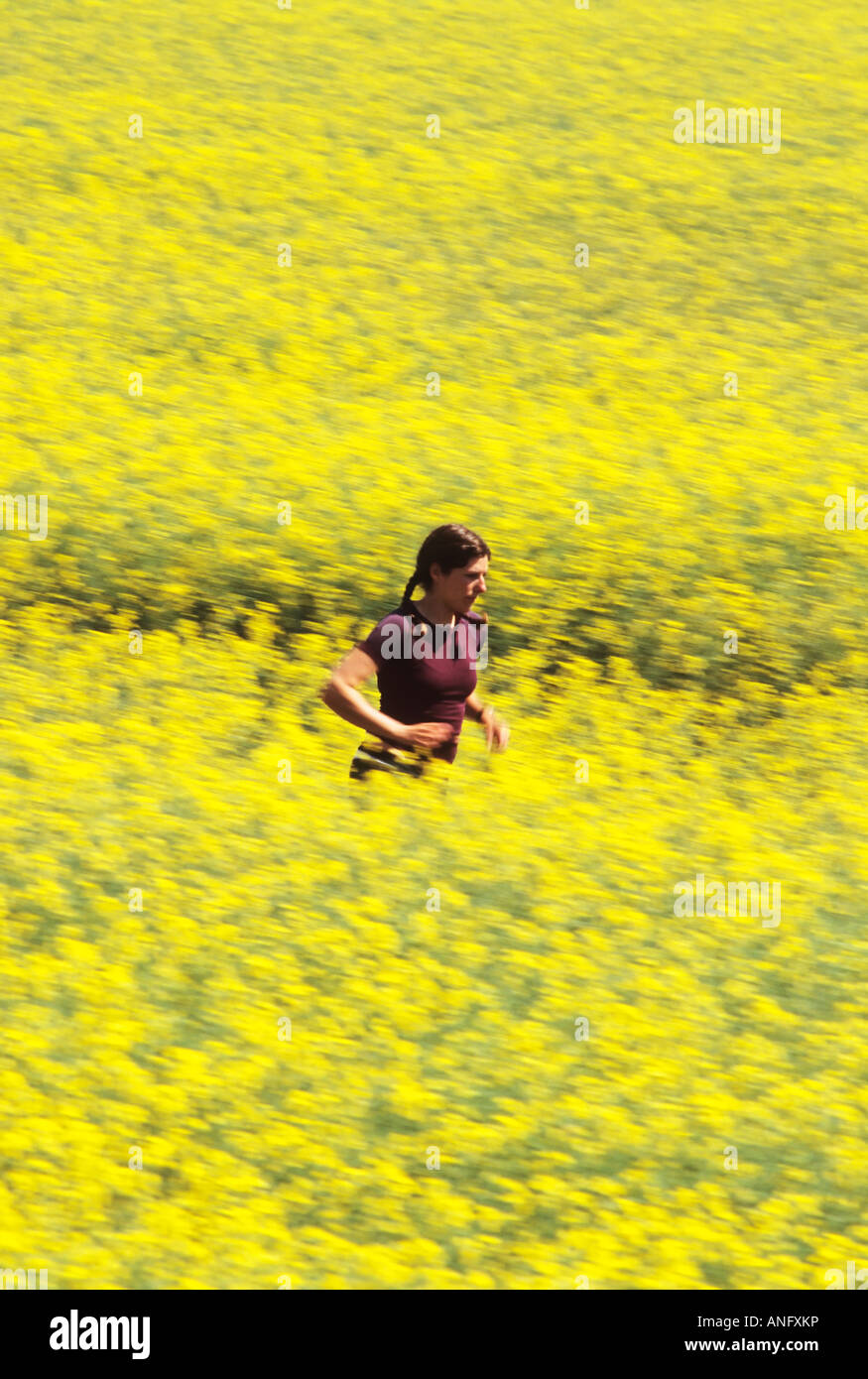 Woman running through flowers hi-res stock photography and images - Alamy