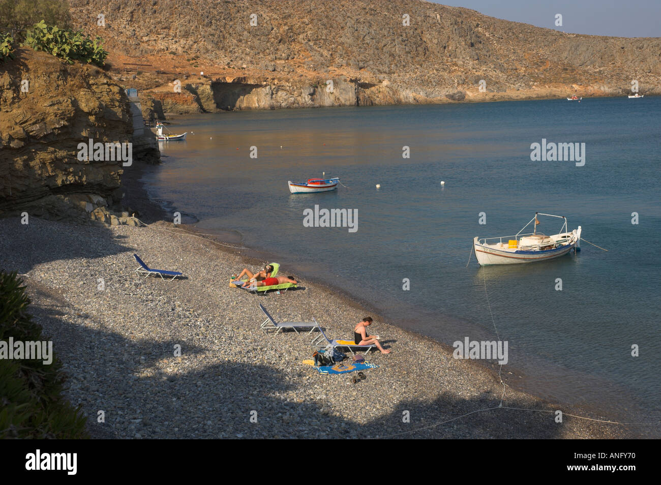 Greece Crete East Coast Kato Zakro people on a pebble beach seen from ...