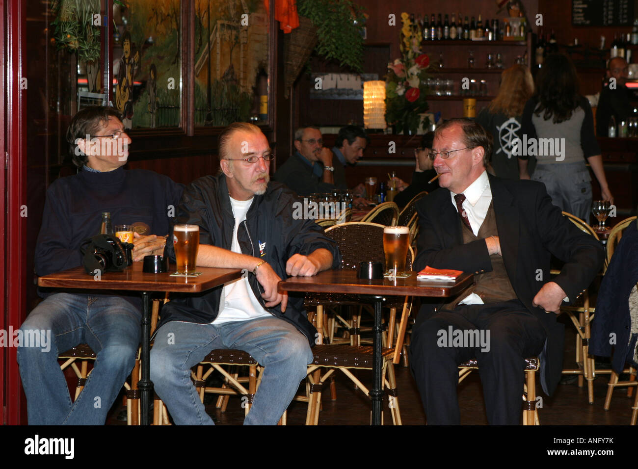 Three 3 male adults drinking beer in a bar in France Stock Photo - Alamy