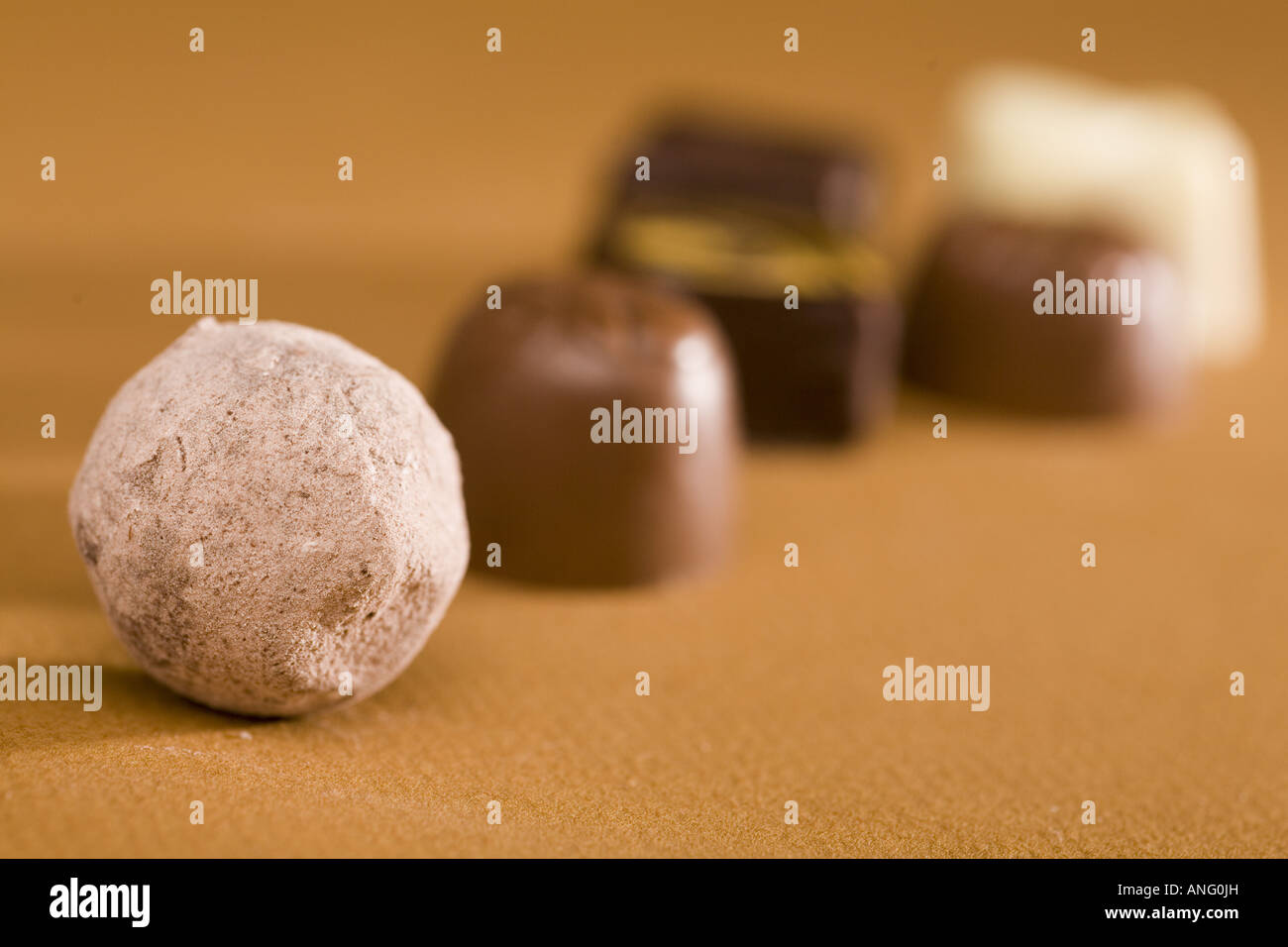 high end chocolate truffles on a brown background Stock Photo - Alamy