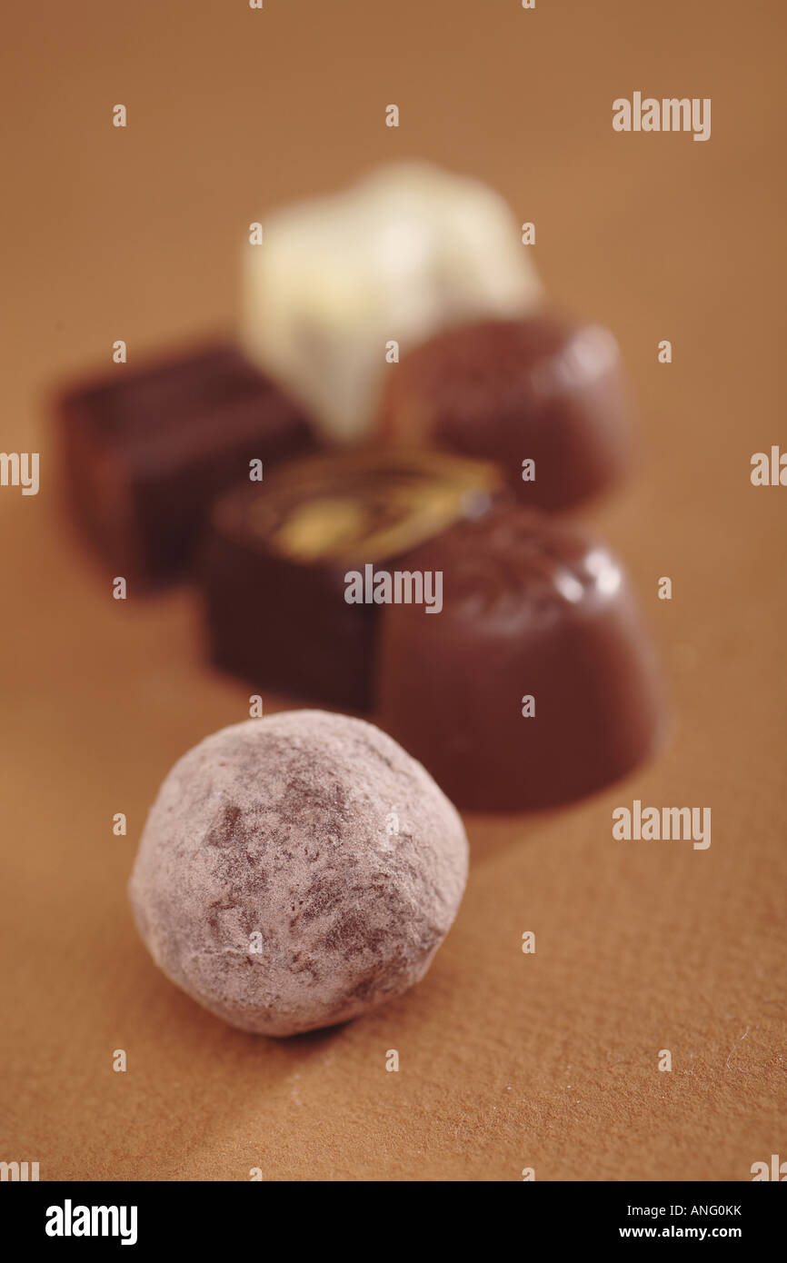 high end chocolate truffles on a brown background Stock Photo - Alamy