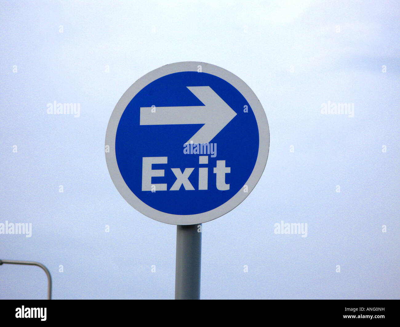 A blue Exit sign pointing right Stock Photo - Alamy