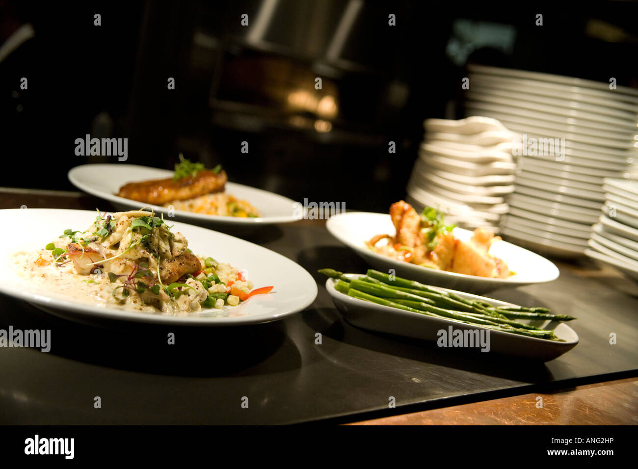 three dinners on line at restaurant to be served Stock Photo - Alamy
