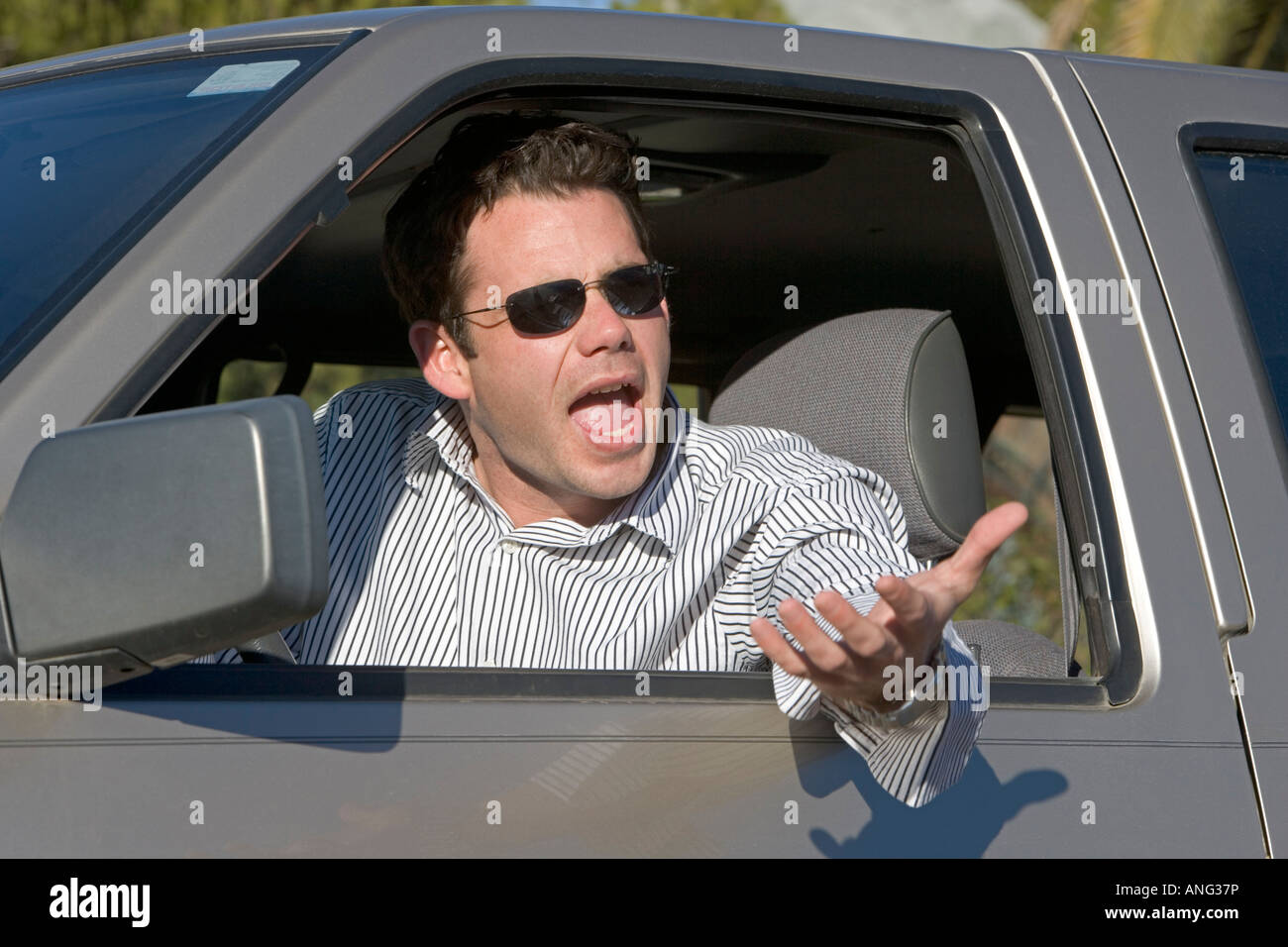 Man in his car yelling at another driver in an an example of road rage ...