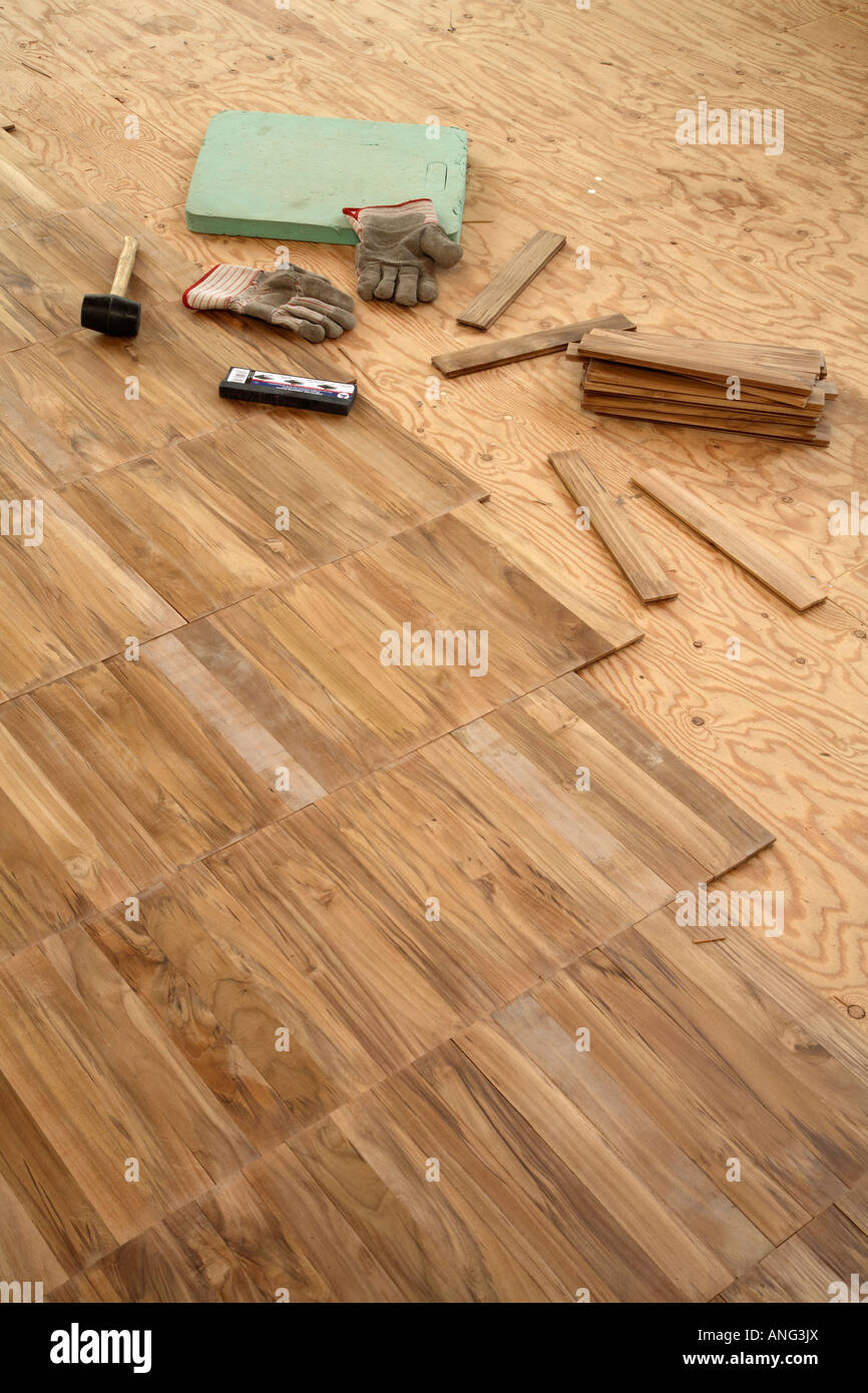Laying a wood parquet flooring Stock Photo - Alamy