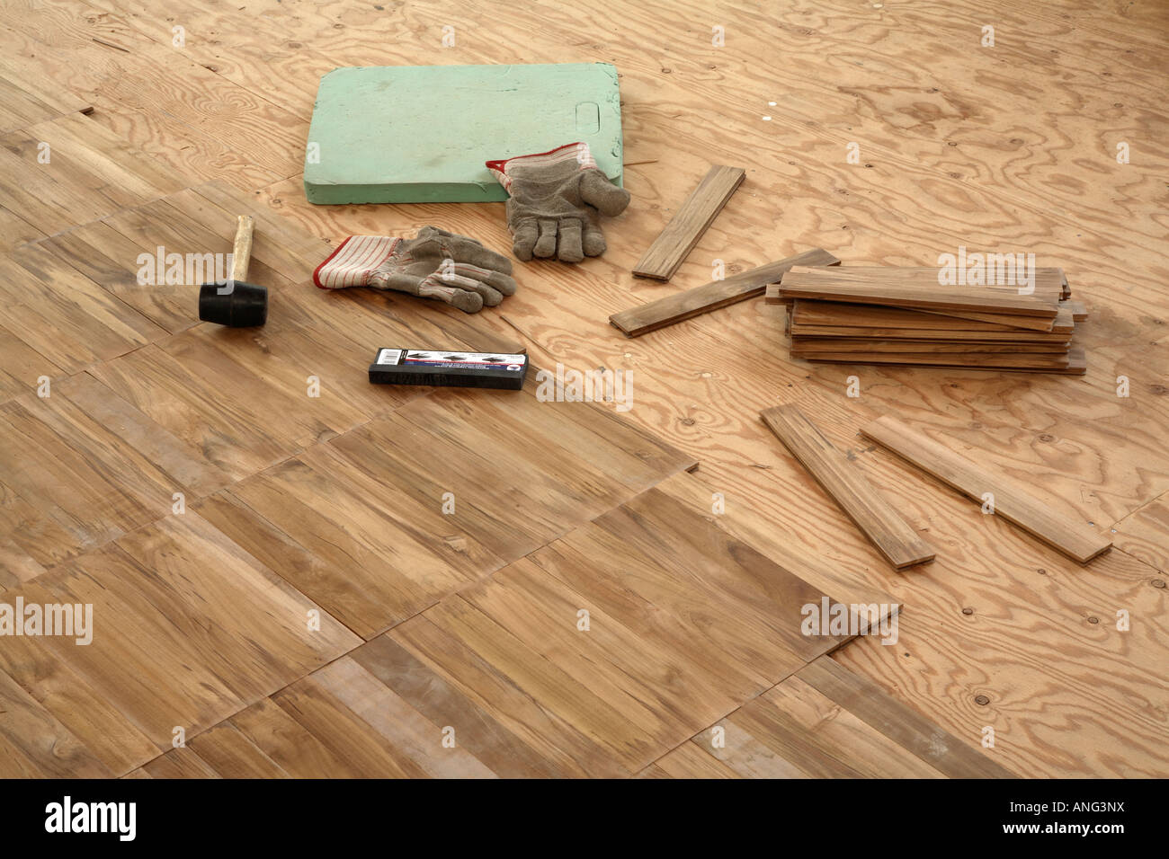Laying a wood parquet flooring Stock Photo - Alamy