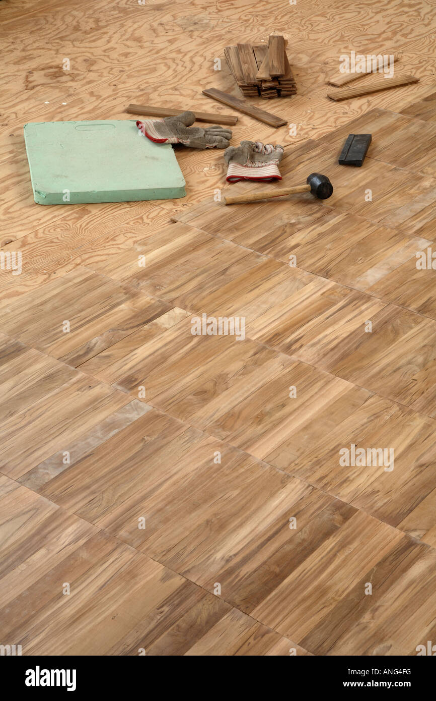 Laying a wood parquet flooring Stock Photo - Alamy