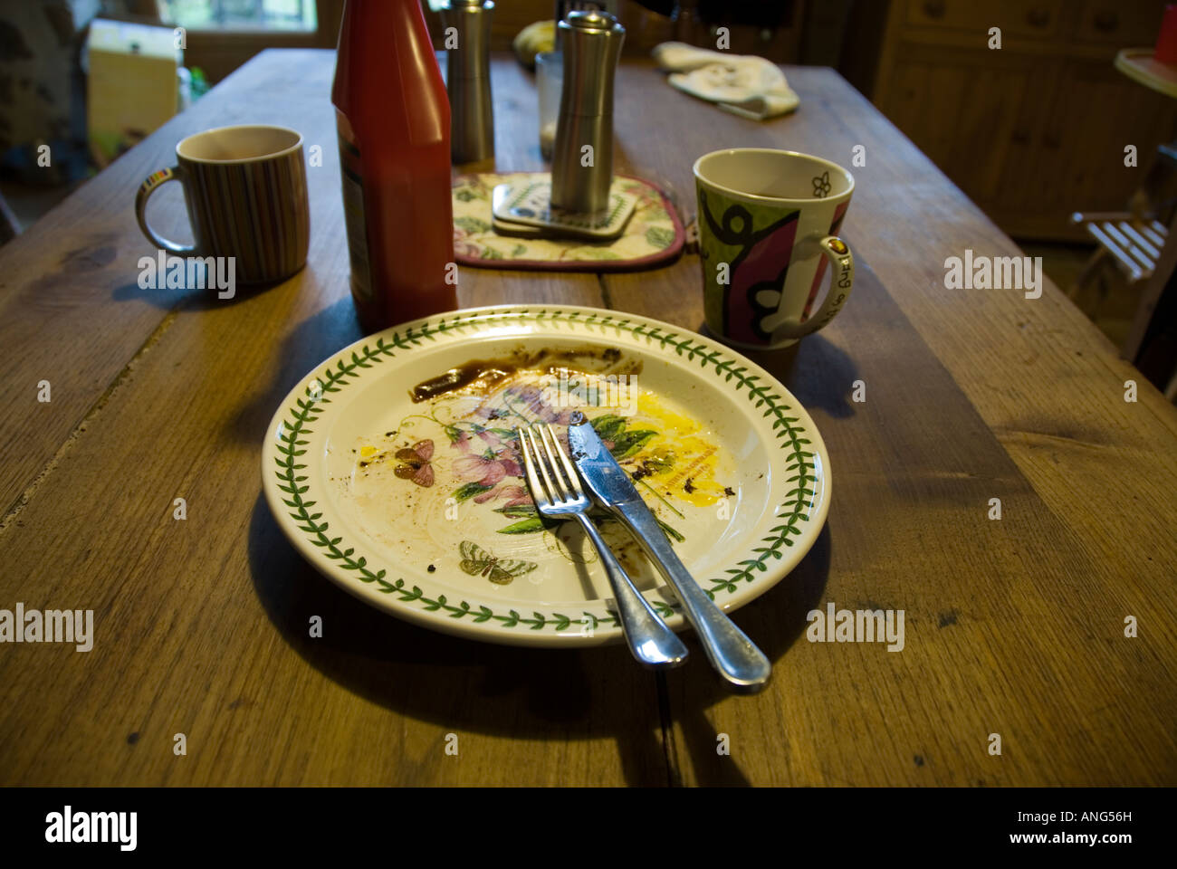 Stock Photo of an empty breakfast plate on a wooden table Stock Photo ...