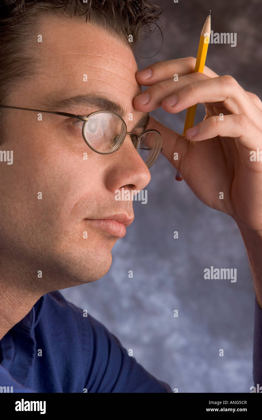 Man thinking writing listening to a lecture Stock Photo - Alamy