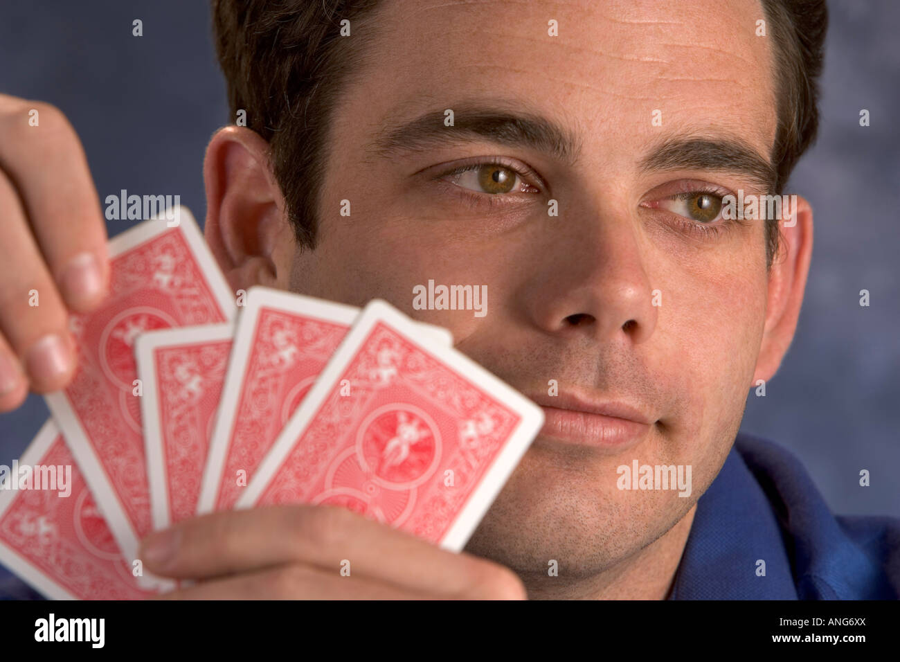 man reaching for a card in his hand Stock Photo - Alamy