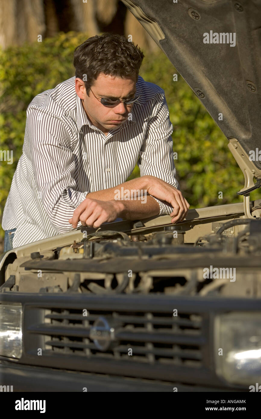 A man struggles to understand what is wrong with his car s motor Stock ...