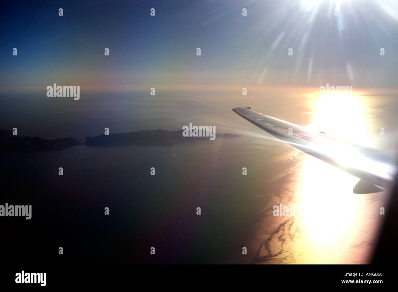 sunset through plane window Stock Photo - Alamy