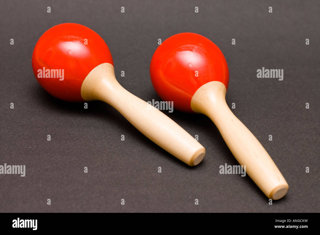 two red rumba shakers on black background Stock Photo - Alamy