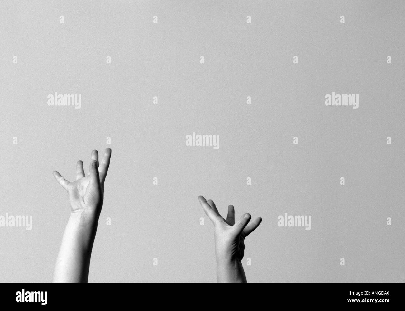 black and white shot off young person hands in the air shot in the ...