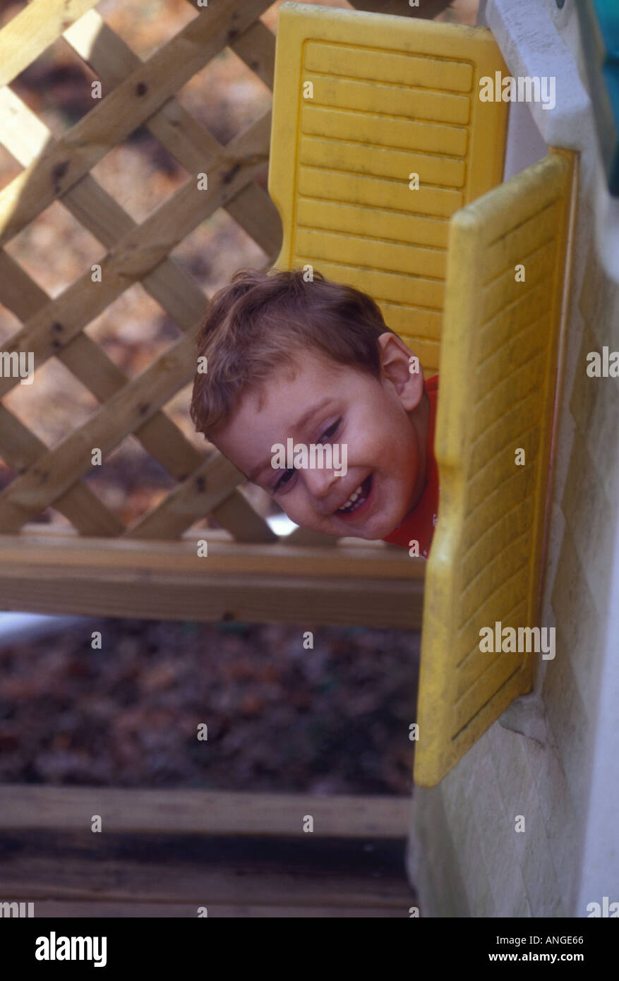Child Peeking out of Playhouse Stock Photo - Alamy