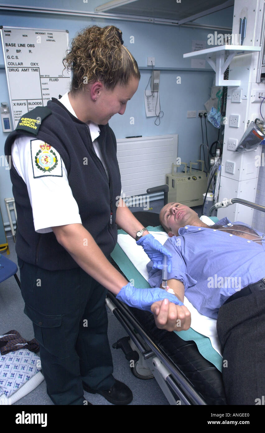 Female ambulance technician with a patient in Accident and Emegency UK ...