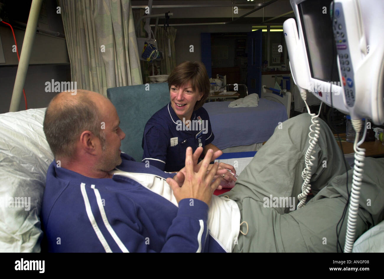 Nurse at the bedside of a patient UK Stock Photo - Alamy