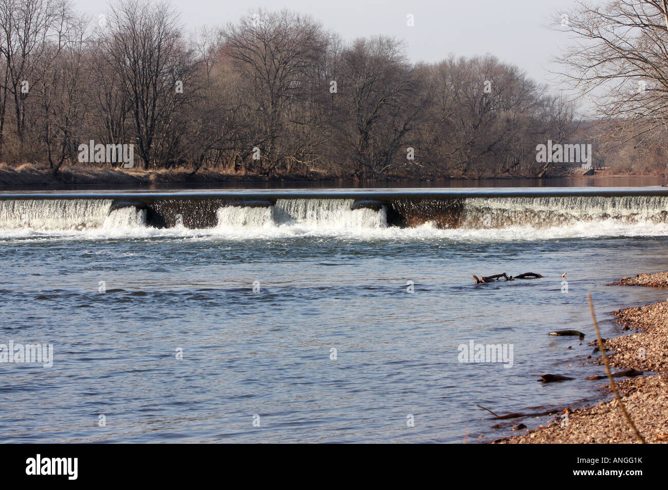 A small waterfall over a dam. Shot in the dead of winter Stock Photo ...