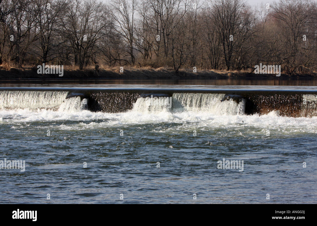 A small waterfall over a dam. Shot in the dead of winter Stock Photo ...