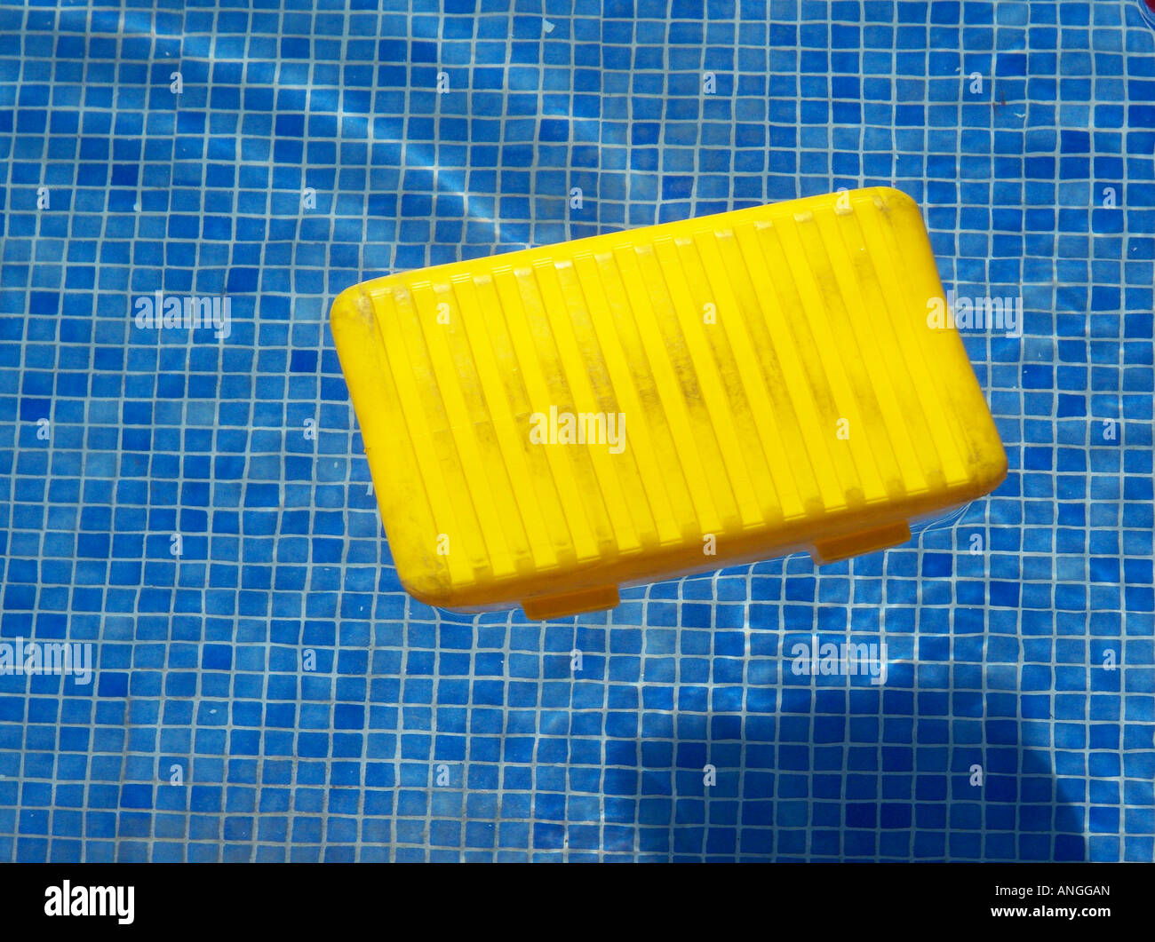 yellow plastic box floating in pool water. Photo by Willy Matheisl ...