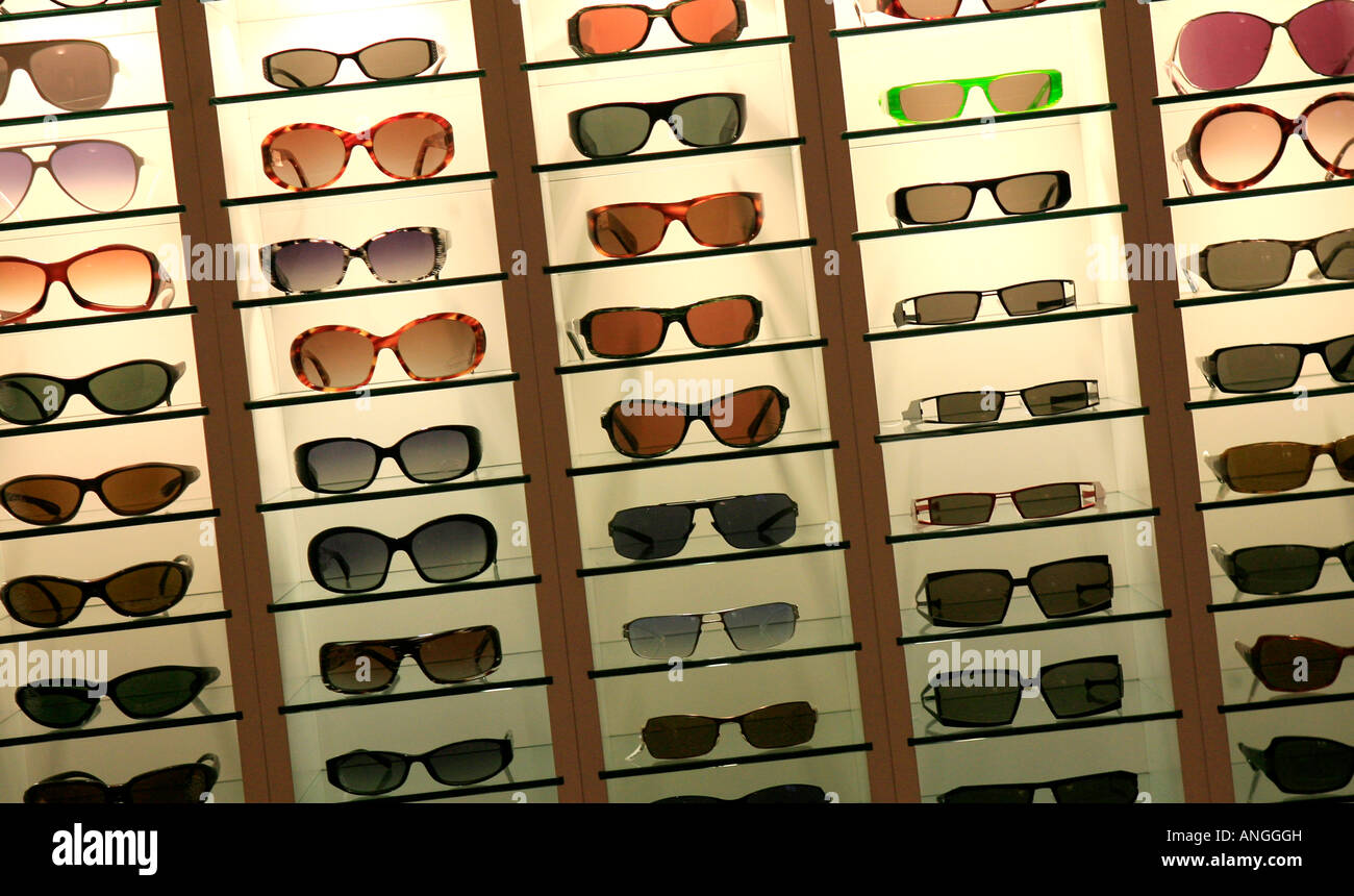Sunglasses on display in an opticians cabinet Stock Photo - Alamy