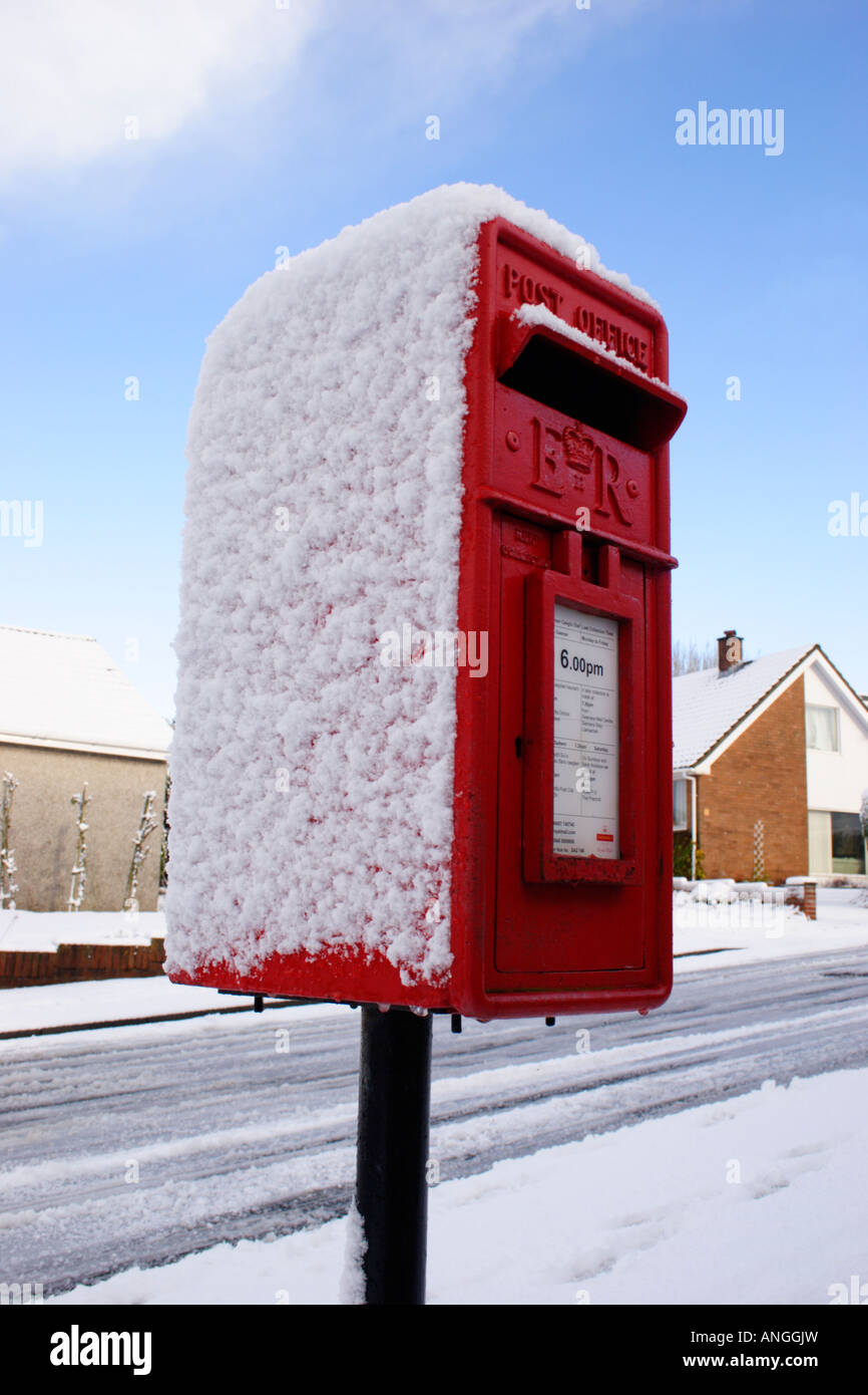 Traditional Red British Post Box In a Suburban Street Covered In Snow ...