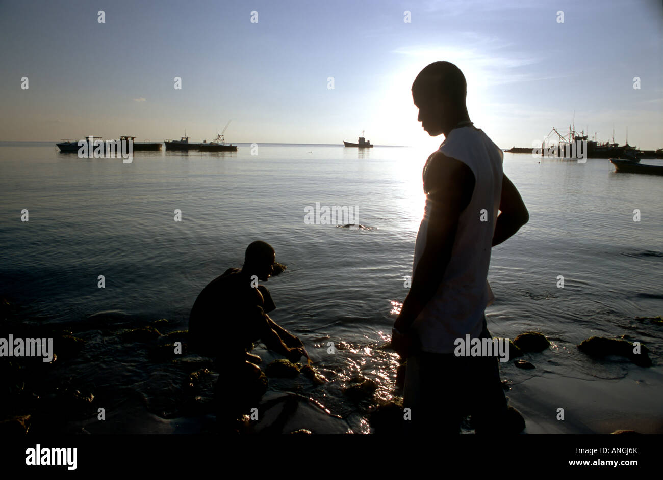Fishermen at sunset. Brig Bay, Big corn island, Nicaragua Stock Photo ...