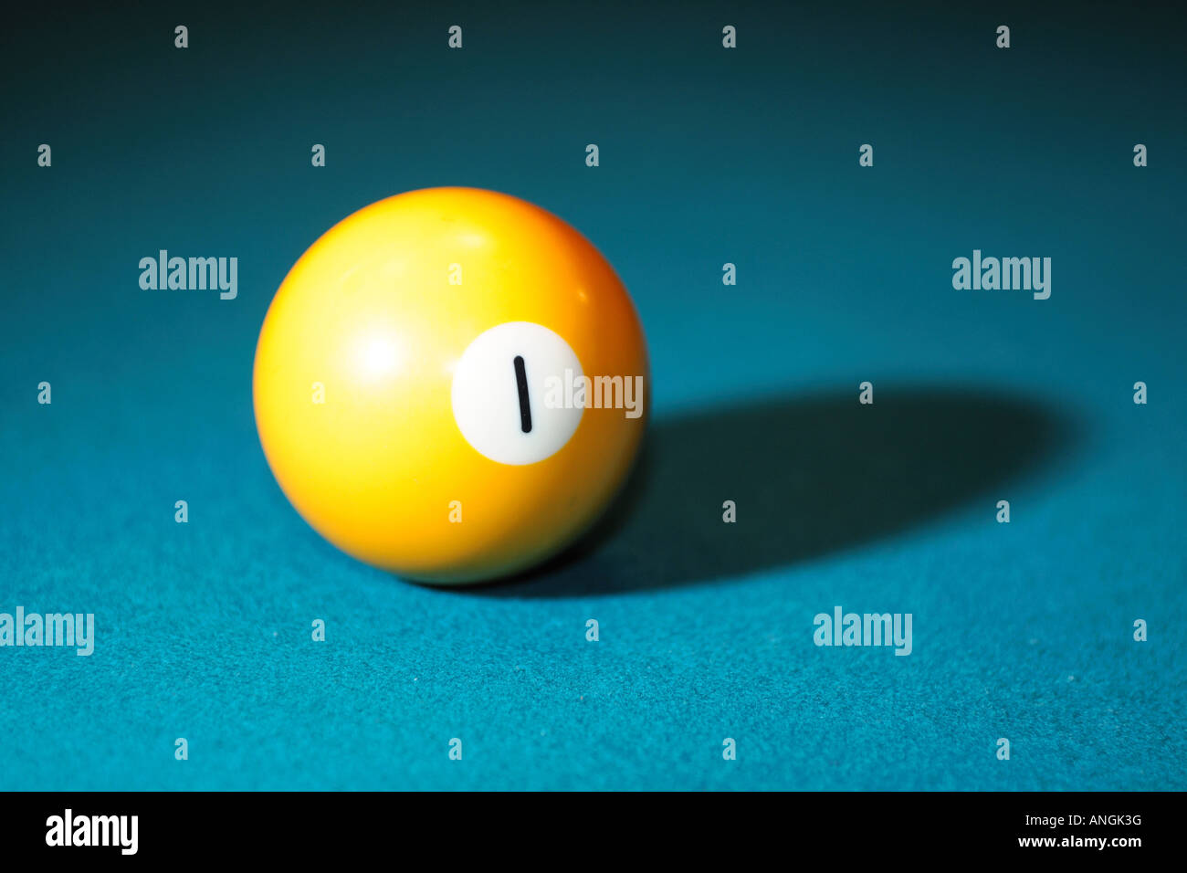 yellow one ball on green pool table Stock Photo - Alamy