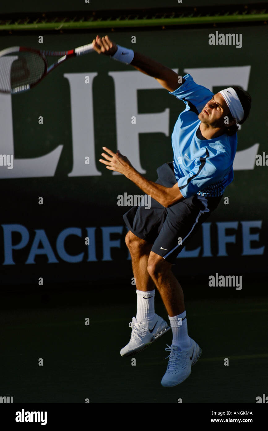Roger Federer serves in a rare doubles appearance at the 2006 Indian ...