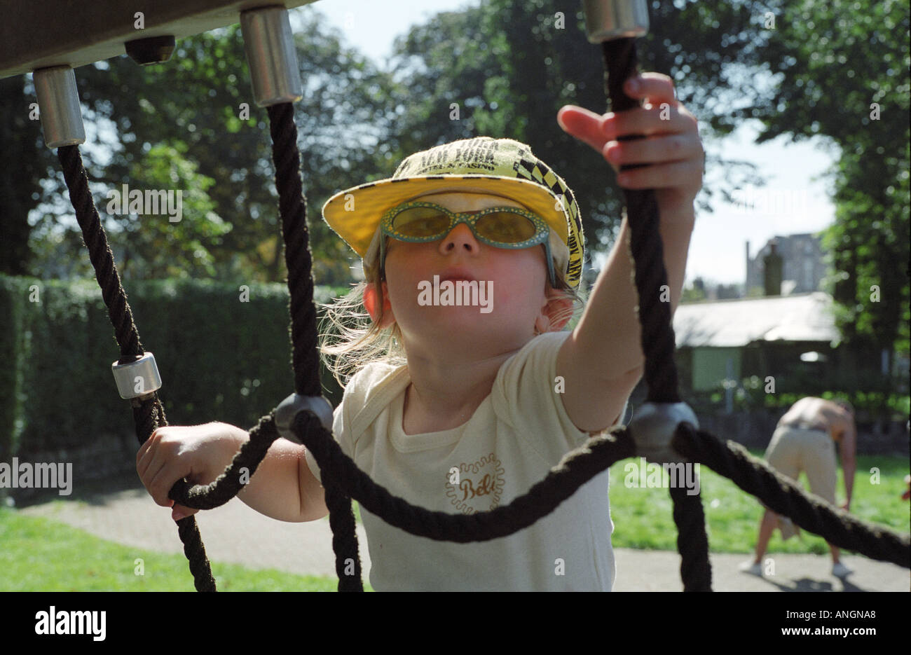small child climbing rope ladder in the sun Stock Photo - Alamy