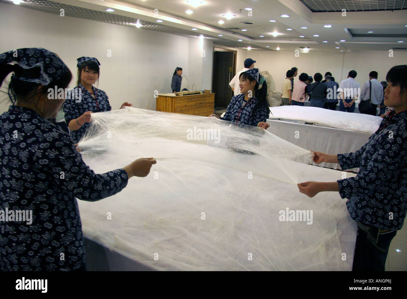Stretching silk at a factory in Beijing China Stock Photo - Alamy