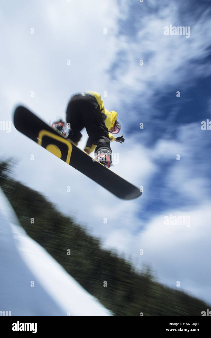 Young male snowboarder catching air at Mt Norquay, Banff National Park ...