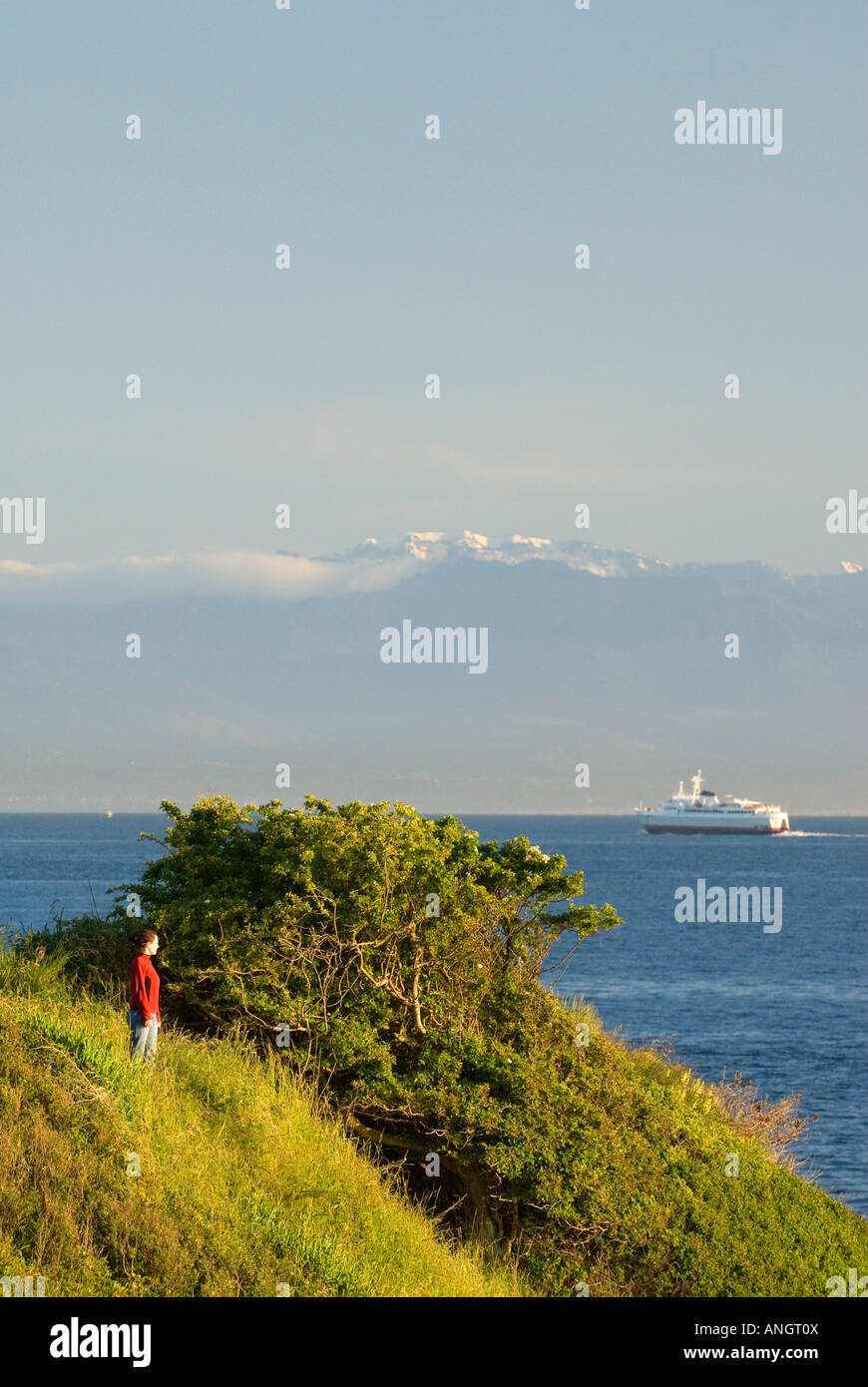 A woman enjoying the view along the Dallas Road waterfront as the Coho ...