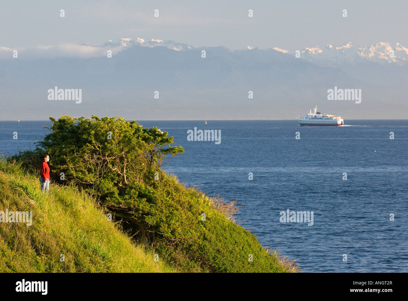 A woman enjoying the view along the Dallas Road waterfront as the Coho ...