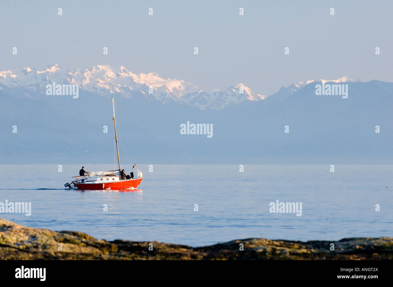 A sailboat passes by the Dallas Road waterfront with the Olympic ...