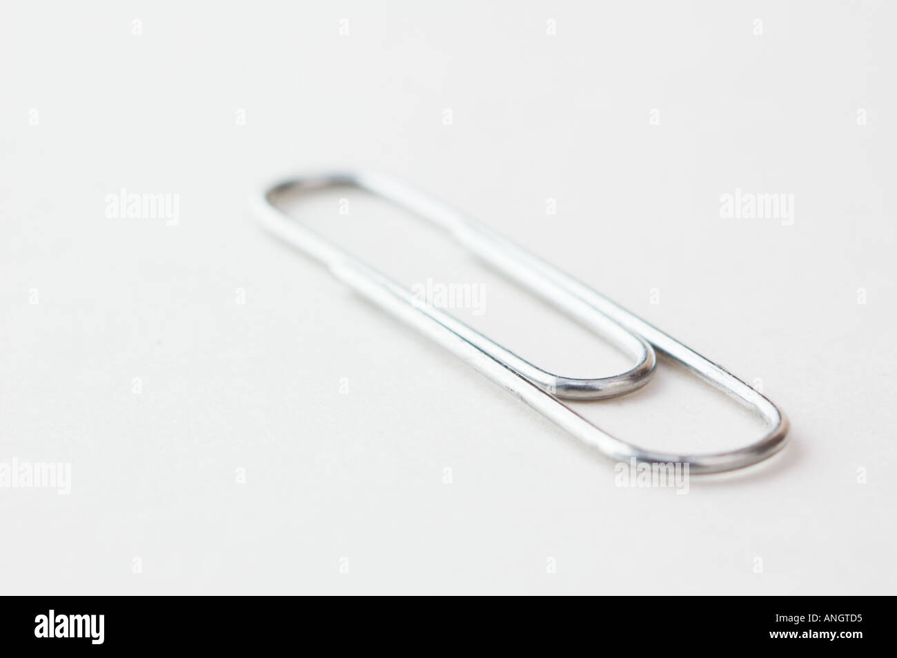 Paperclip on white background Stock Photo - Alamy