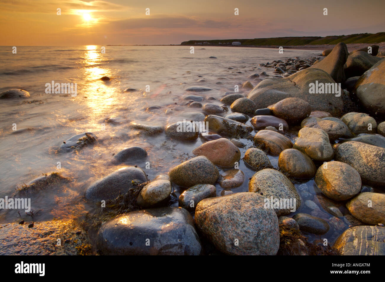 The rocky shoreline of Green Point at sunset, Gros Morne National Park ...