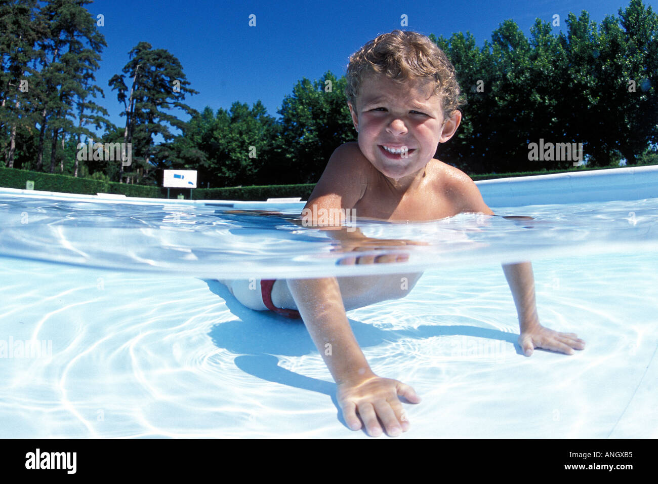 boy laying in the pool Stock Photo - Alamy