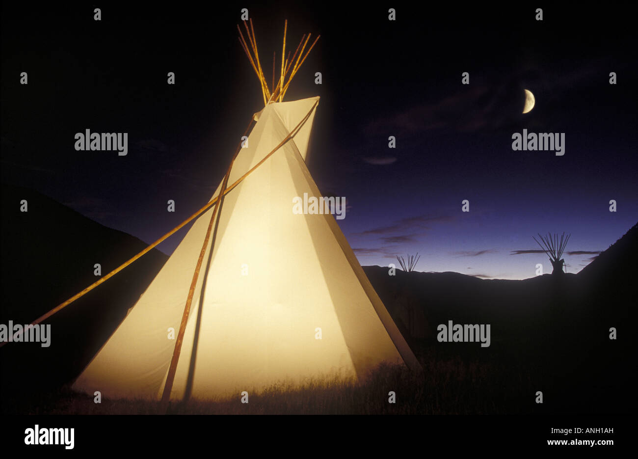 First Nations tee-pee village above the Fraser River at night with ...